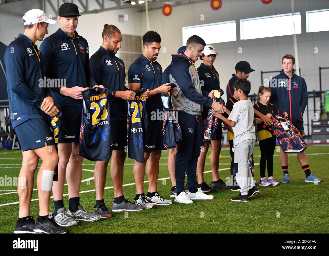 Crows players are seen handing out indigenous guernseys with indigenous ...