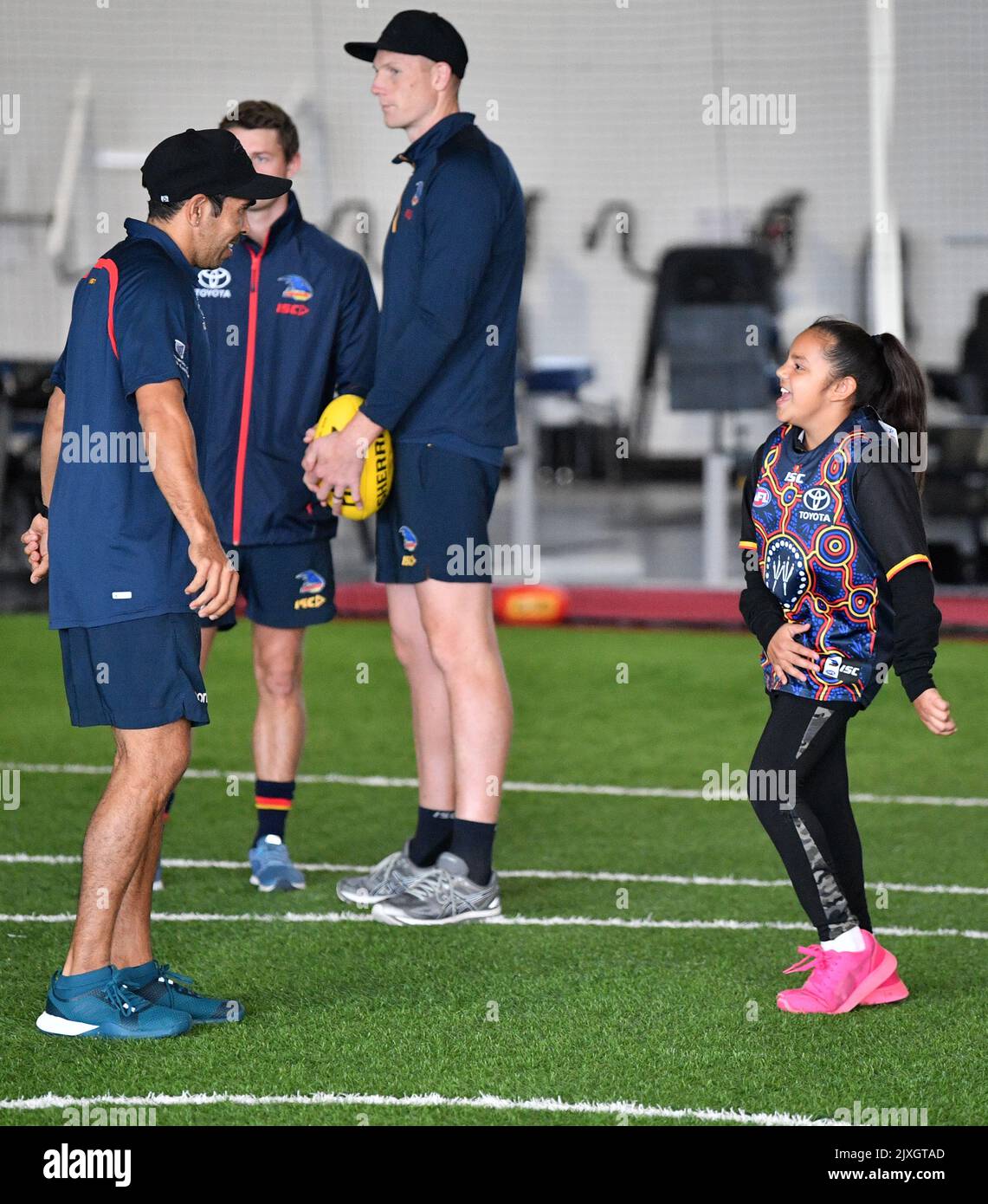 Eddie Betts of the Crows is seen with Amelia Rankine during a visit by ...