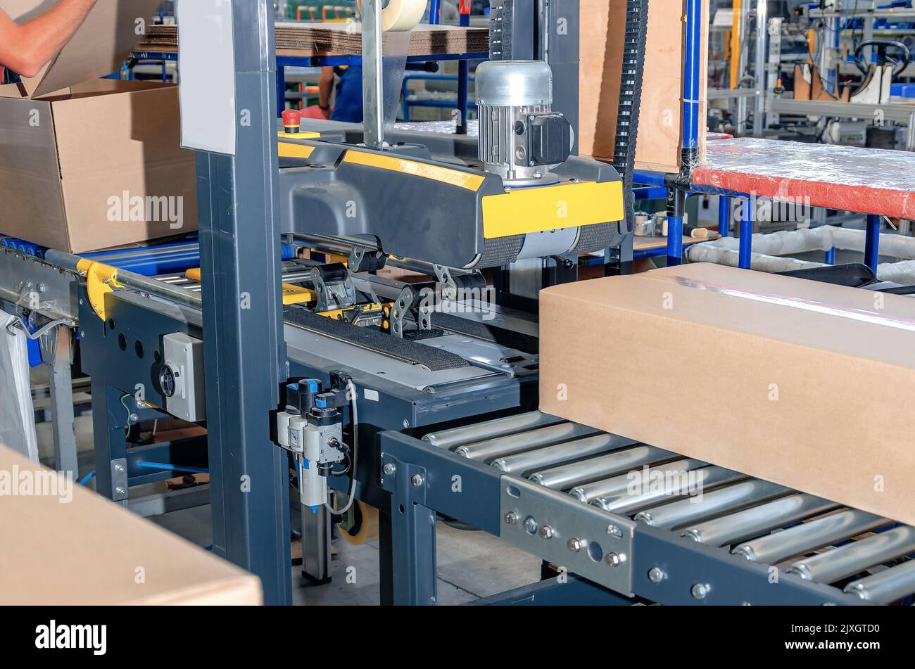 Cardboard packaging machine. Production line of packaging. Industry ...