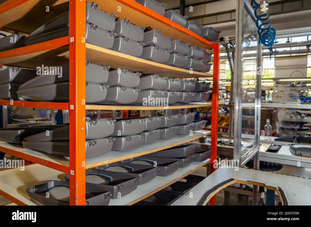 Shelves with gray plastic containers in production. Storage. Industrial ...