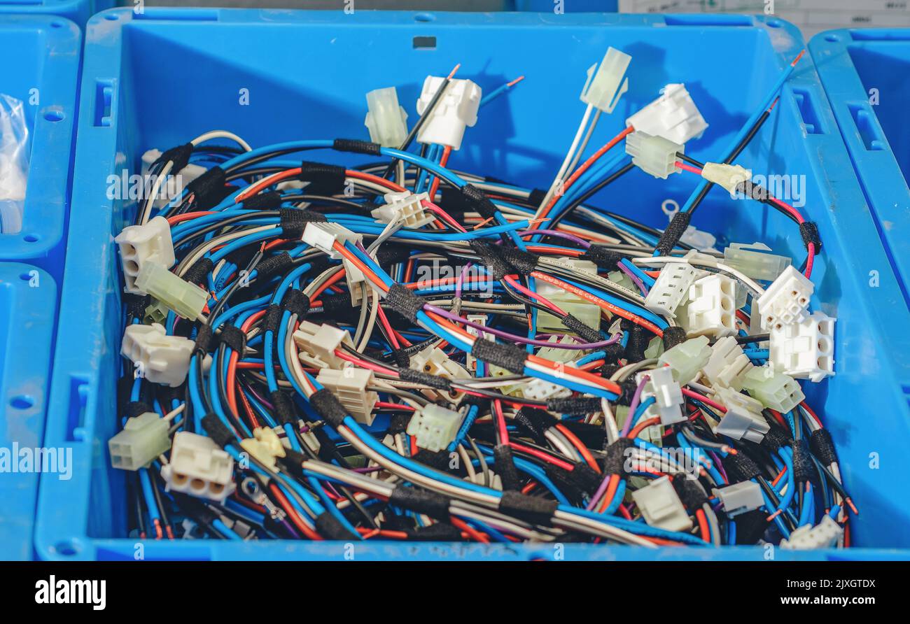 Blue container with bunch of colored cables, connections, wires ...