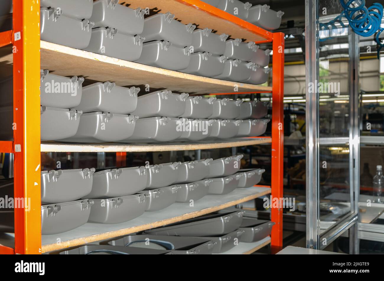 Shelves with gray plastic containers in production. Storage. Industrial ...
