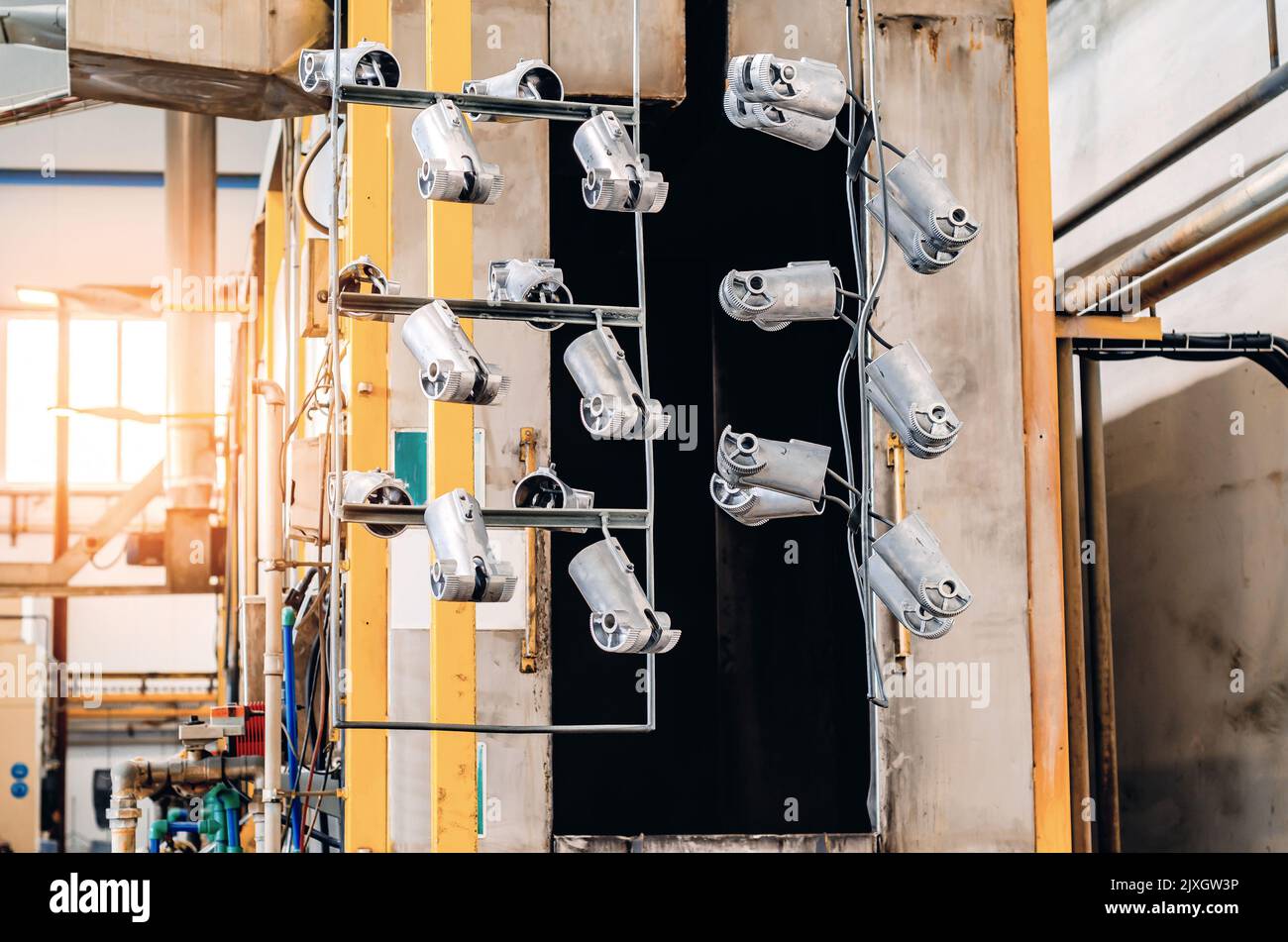 Production details hung on metal hangers in workshop. Strong, rough ...