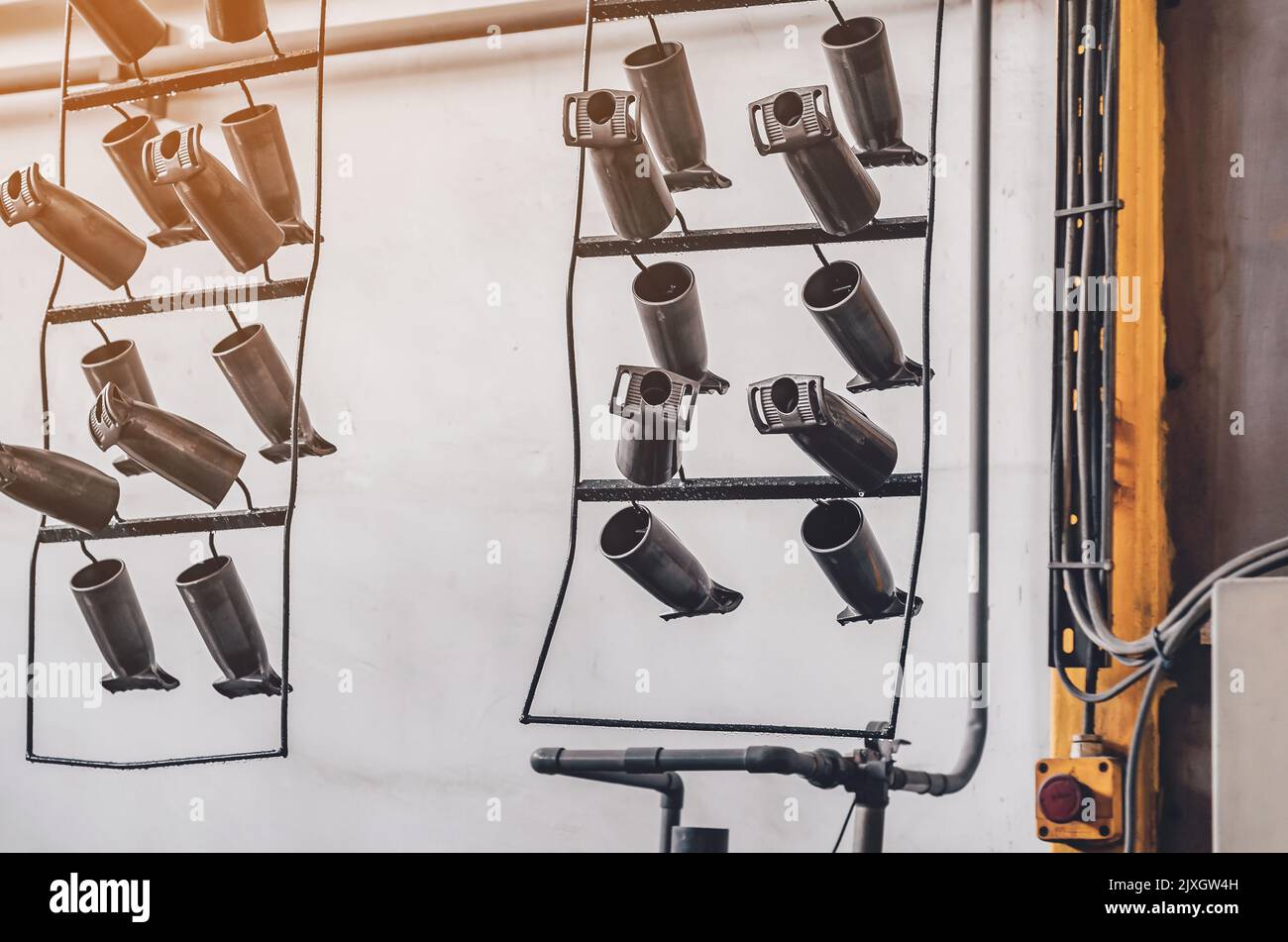 Production details hung on metal hangers in workshop. Strong, rough ...