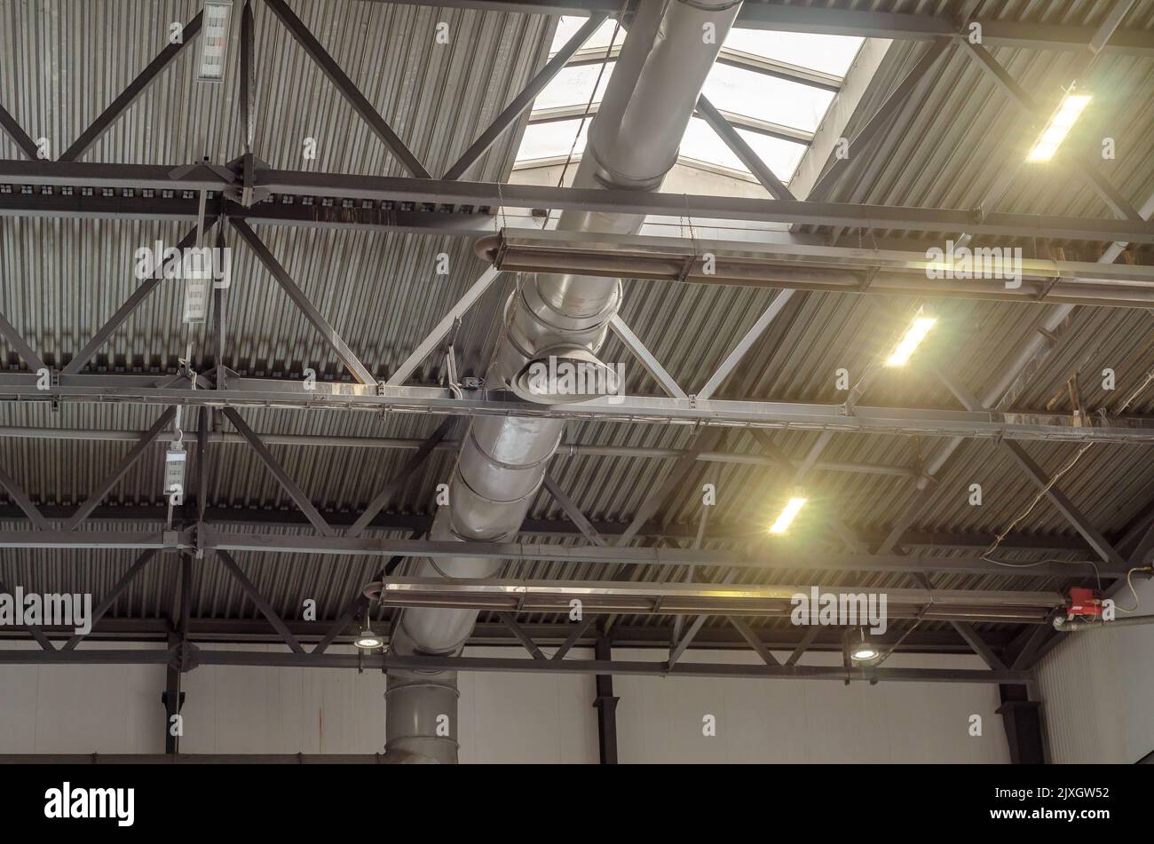 Ceiling of large factory building with artificial lighting. Industrial ...