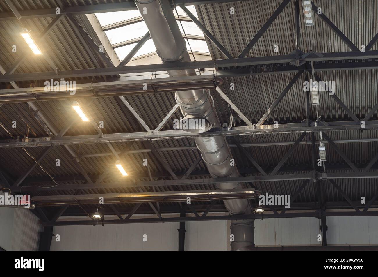 Ceiling of large factory building with artificial lighting. Industrial ...