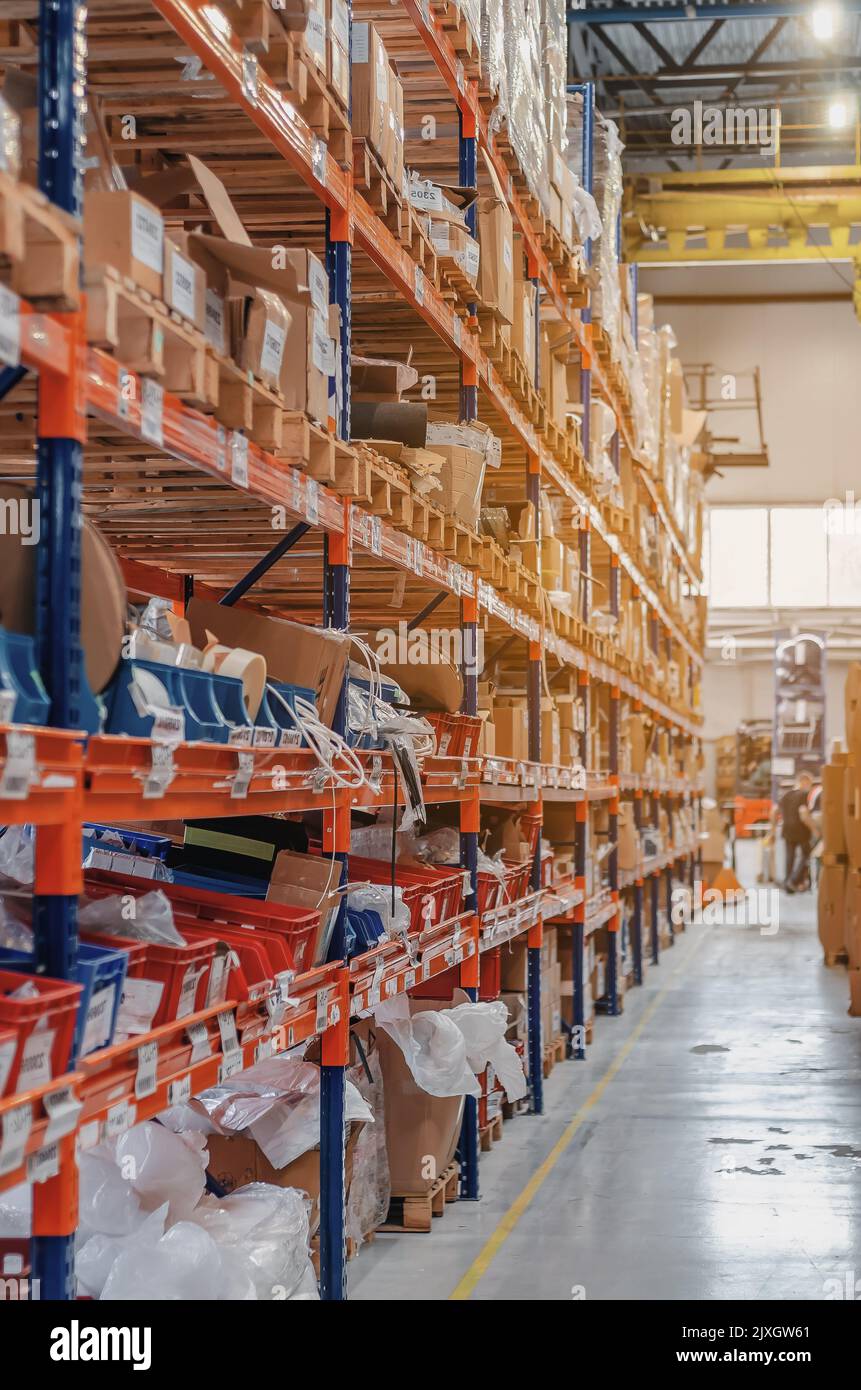 Storage with high shelves. Rows of shelves with boxes at factory ...