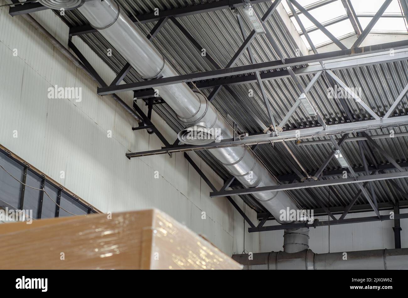 Ceiling of large factory building with artificial lighting. Industrial ...