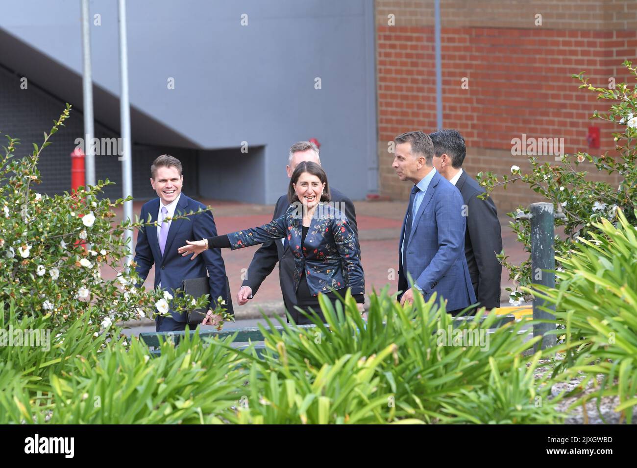NSW Premier Gladys Berejiklian (centre) arrives to a press conference ...
