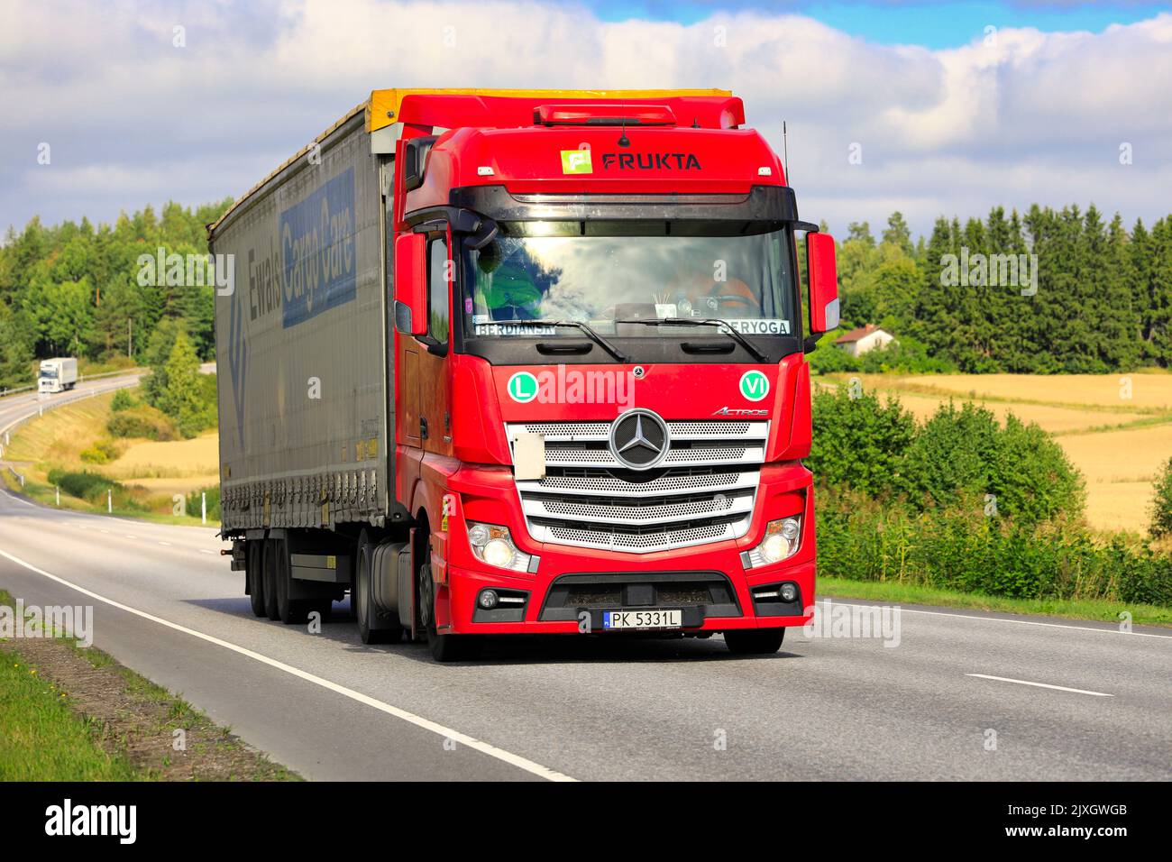 Red Mercedes-Benz Actros 1851 truck Frukta pulls semi trailer along ...