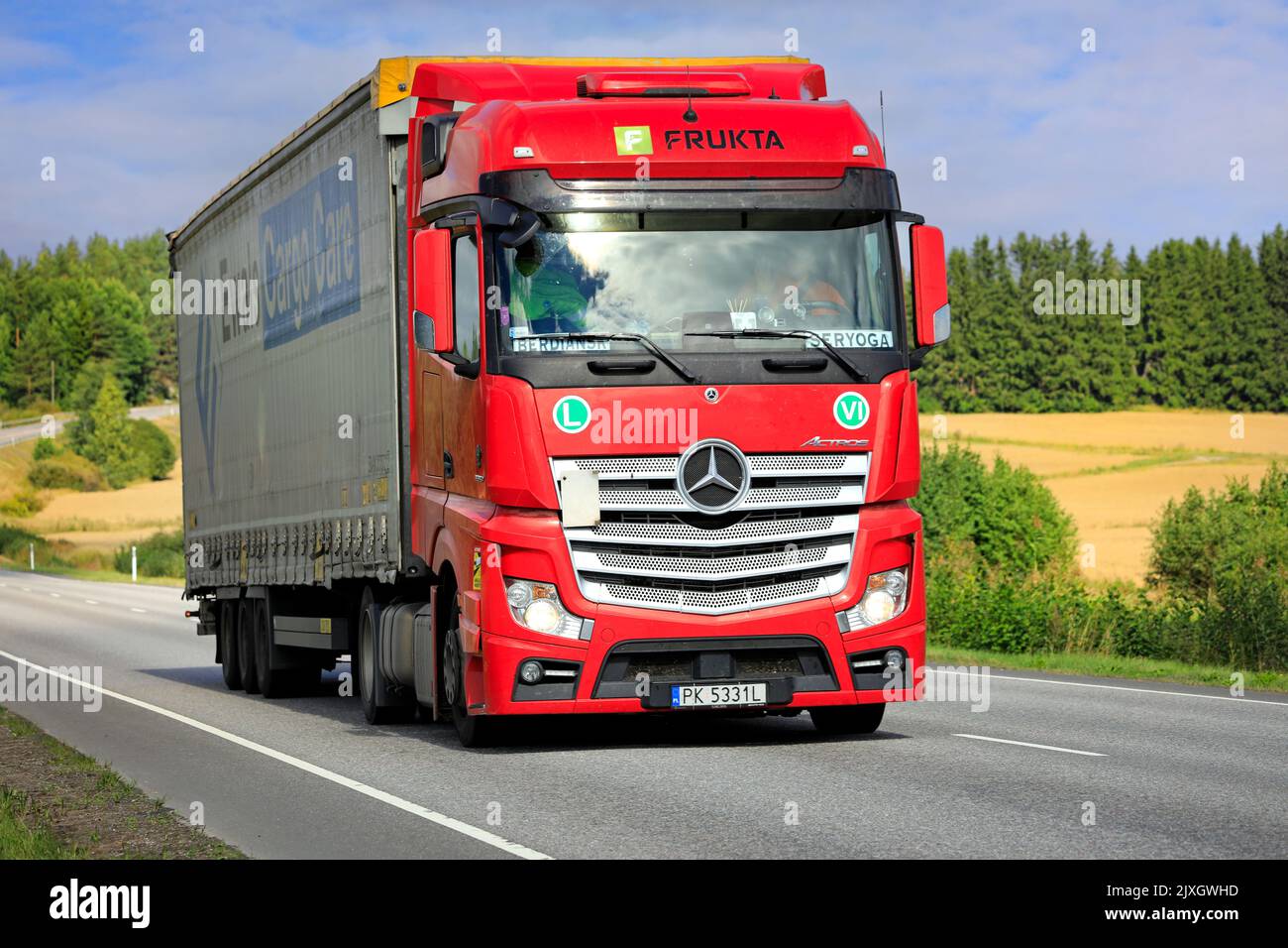 Red Mercedes-Benz Actros 1851 Frukta pulls semi trailer along highway ...