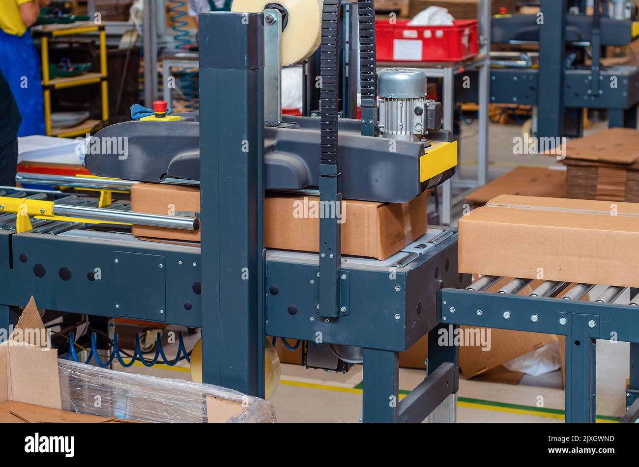 Side view cardboard packaging machine. Production line of packaging ...