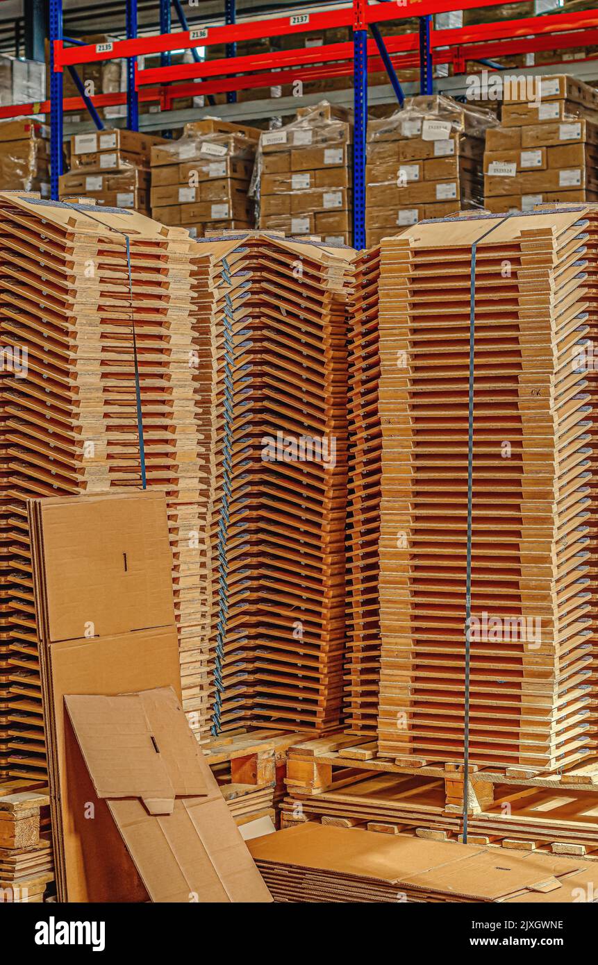 Wooden parts in stacks in factory warehouse. Wooden parts for lighting ...