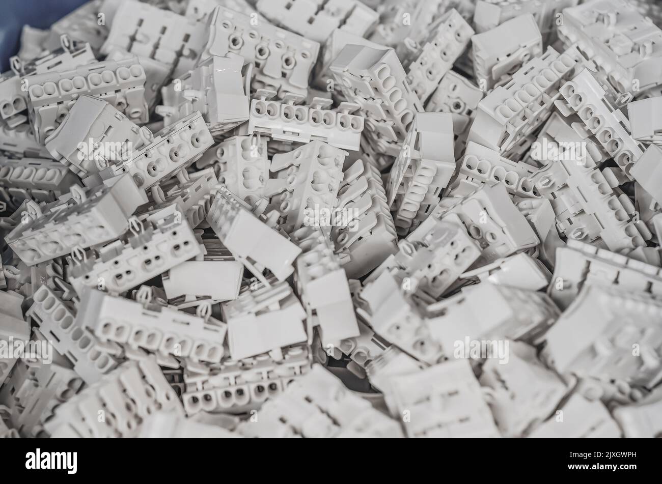 Pile of white electrical connection blocks for cables. Abstract ...