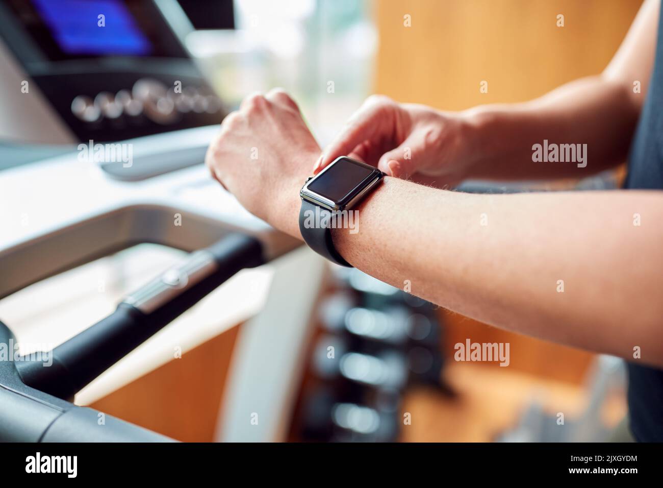 Close Up Of Woman In Gym Using Fitness App On Smart Watch On Running ...