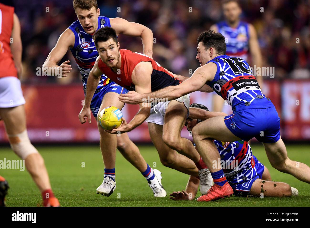 Alex Neal-Bullen of the Demons beats a tackle by Toby McLean of the ...
