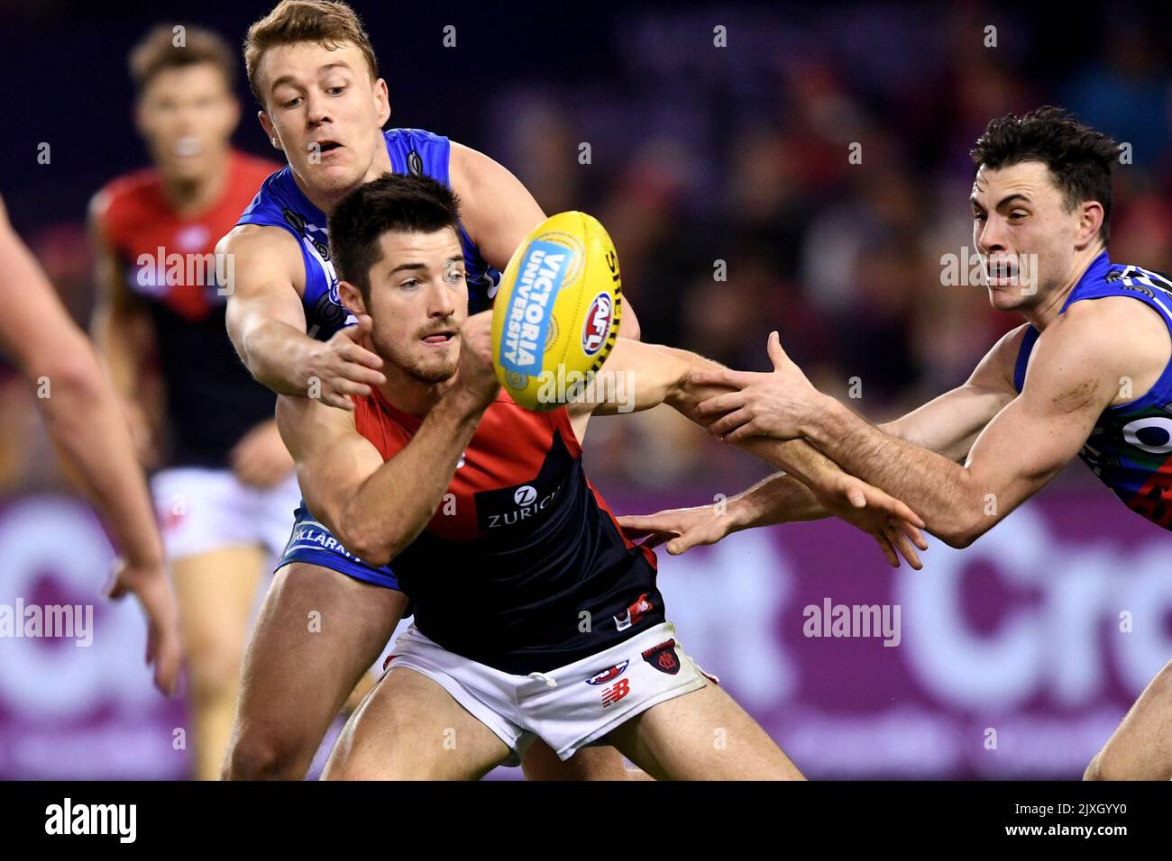 Alex Neal-Bullen of the Demons beats a tackle by Toby McLean of the ...