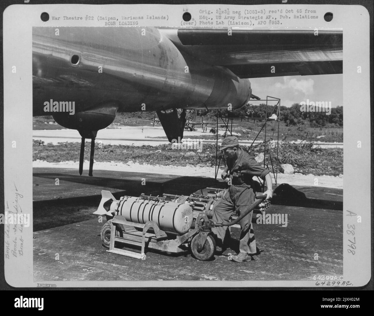 In Preparation For A Bombing Mission Over Tokyo, Japanesean, An Armorer Moves Bomb Dolly Holding ...