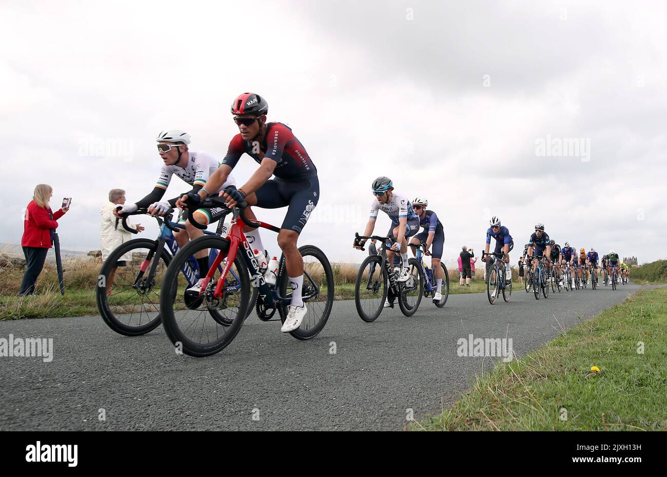 The peloton passes Whitby Abbey during stage four of the AJ Bell Tour ...