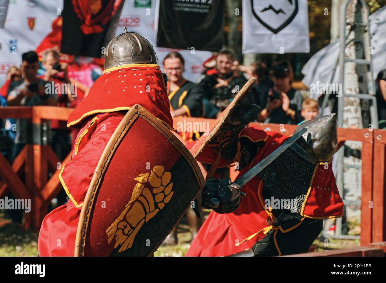 Sword fighting. The knight's shield shows a Golden glove Stock Photo ...