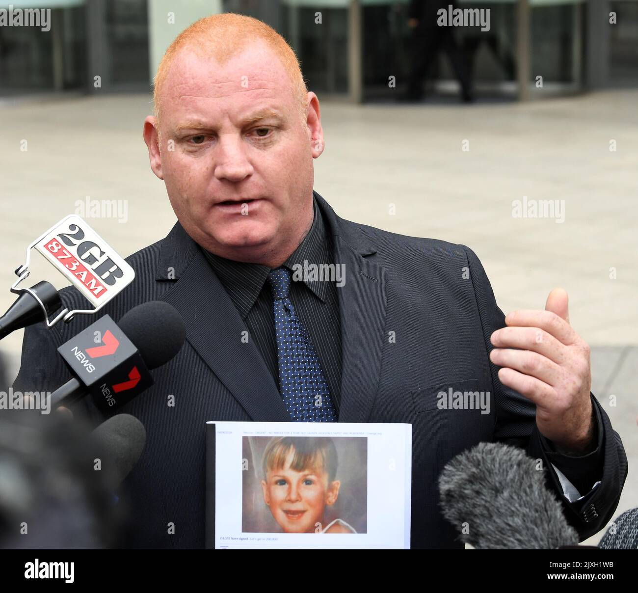 Robert Miell, the cousin of Lauren Hickson, holds a photo of Lauren as ...