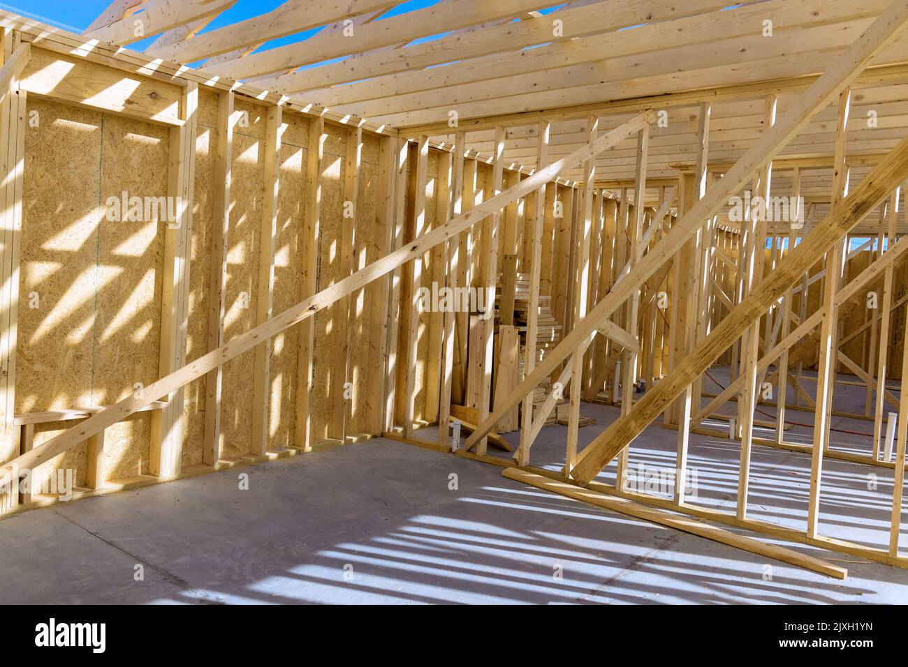 There are beams of wood stick framing in the construction of a new ...