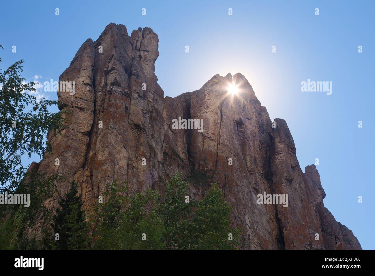 The sun shines through a crack in stone pillars Stock Photo - Alamy