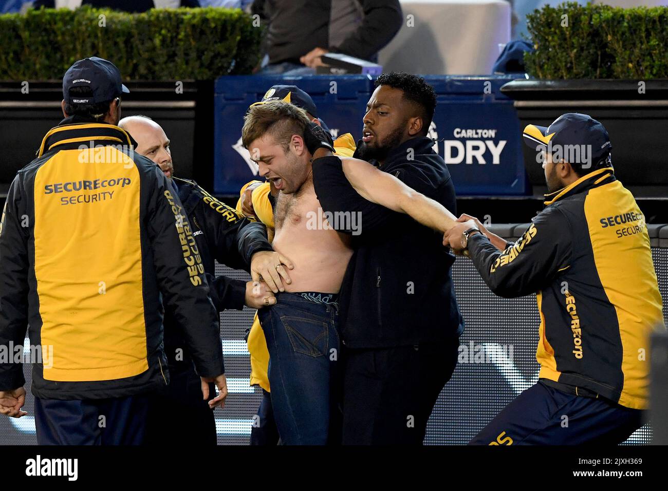 Security wrestle with a pitch invader during Game 1 of the 2018 State ...