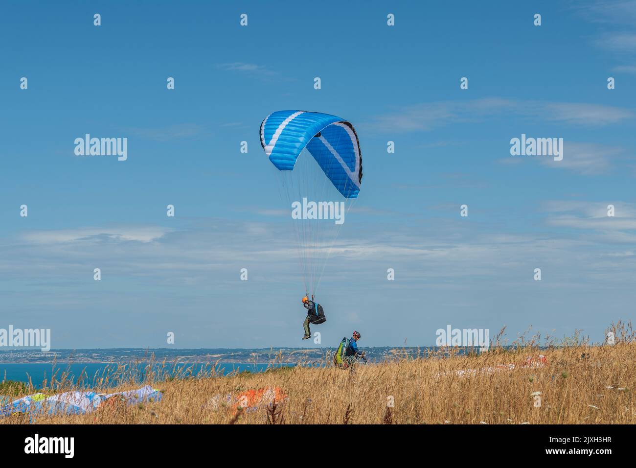 Paragliding flight over the beach on the cliffs Stock Photo - Alamy
