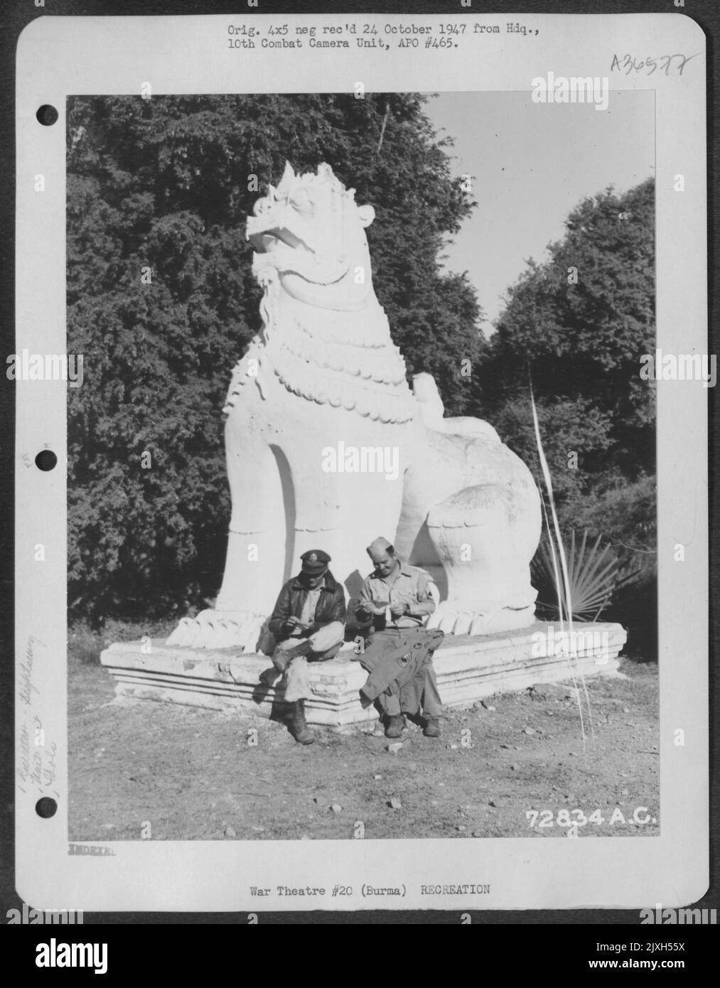 Two Men Of The 1St Air Commando Group Relax At The Feet Of A Burmese ...