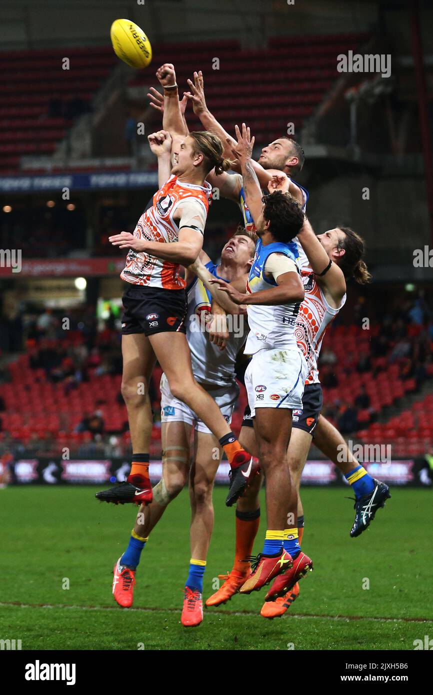 Suns and Giants players contests the ball during the Round 12 AFL match ...