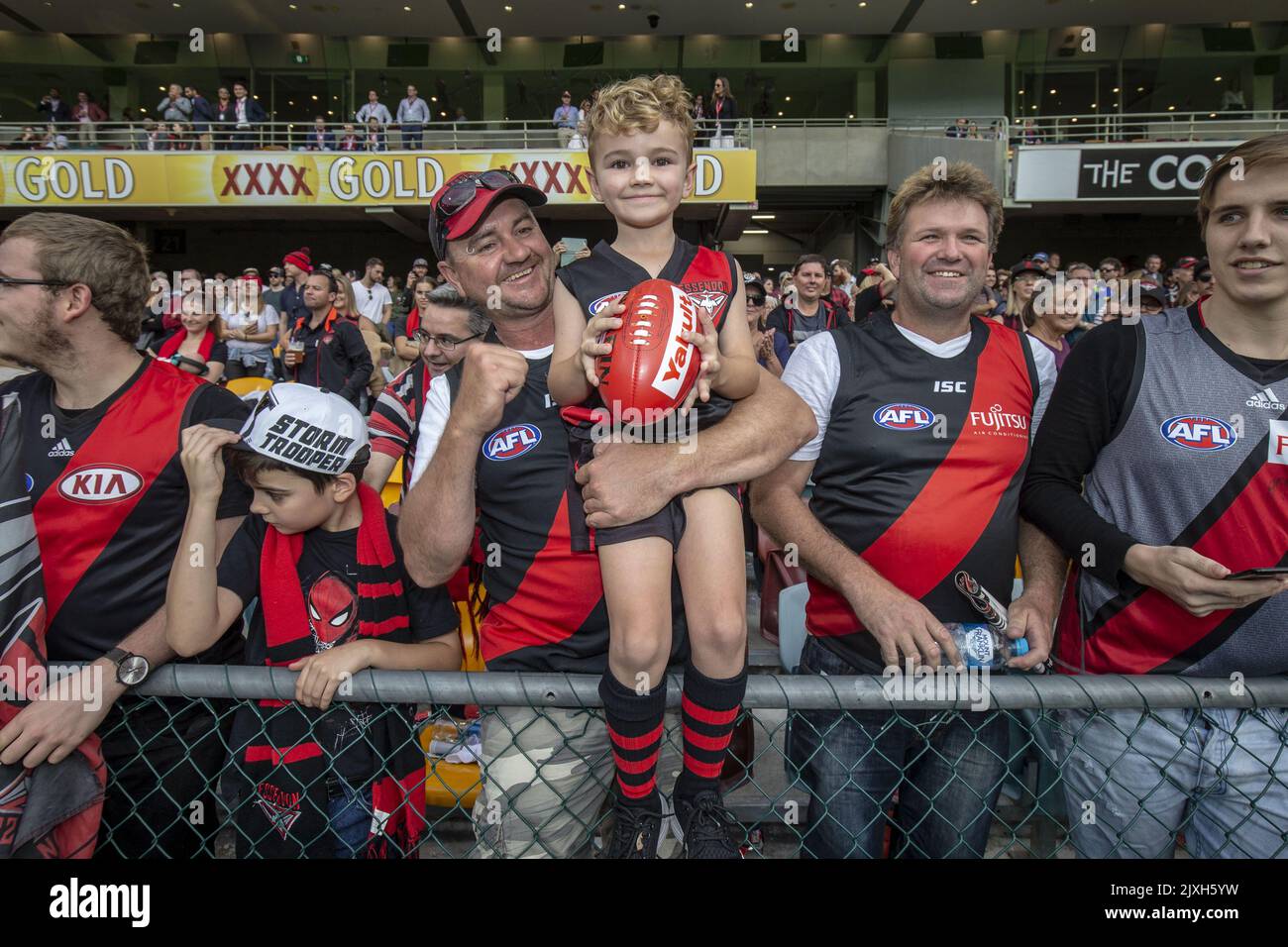 8 year-old Mullah Cloke with his father Tony receives a football from ...