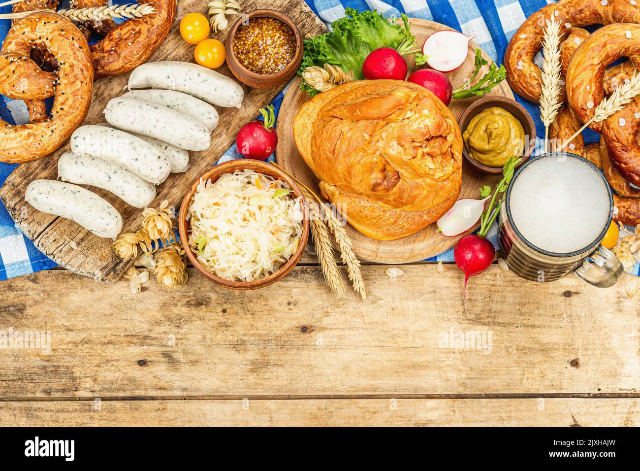 Traditional Oktoberfest set. Pretzels, beer, weisswurst, smoked pork ...