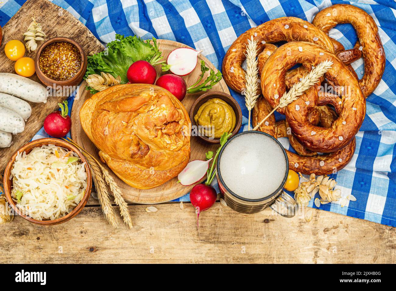 Traditional Oktoberfest set. Pretzels, beer, weisswurst, smoked pork ...