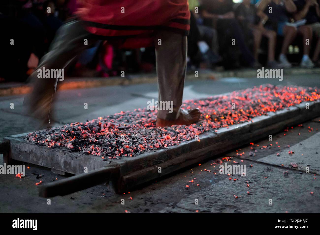 Ritual of a man walking on the embers of a fire Stock Photo - Alamy