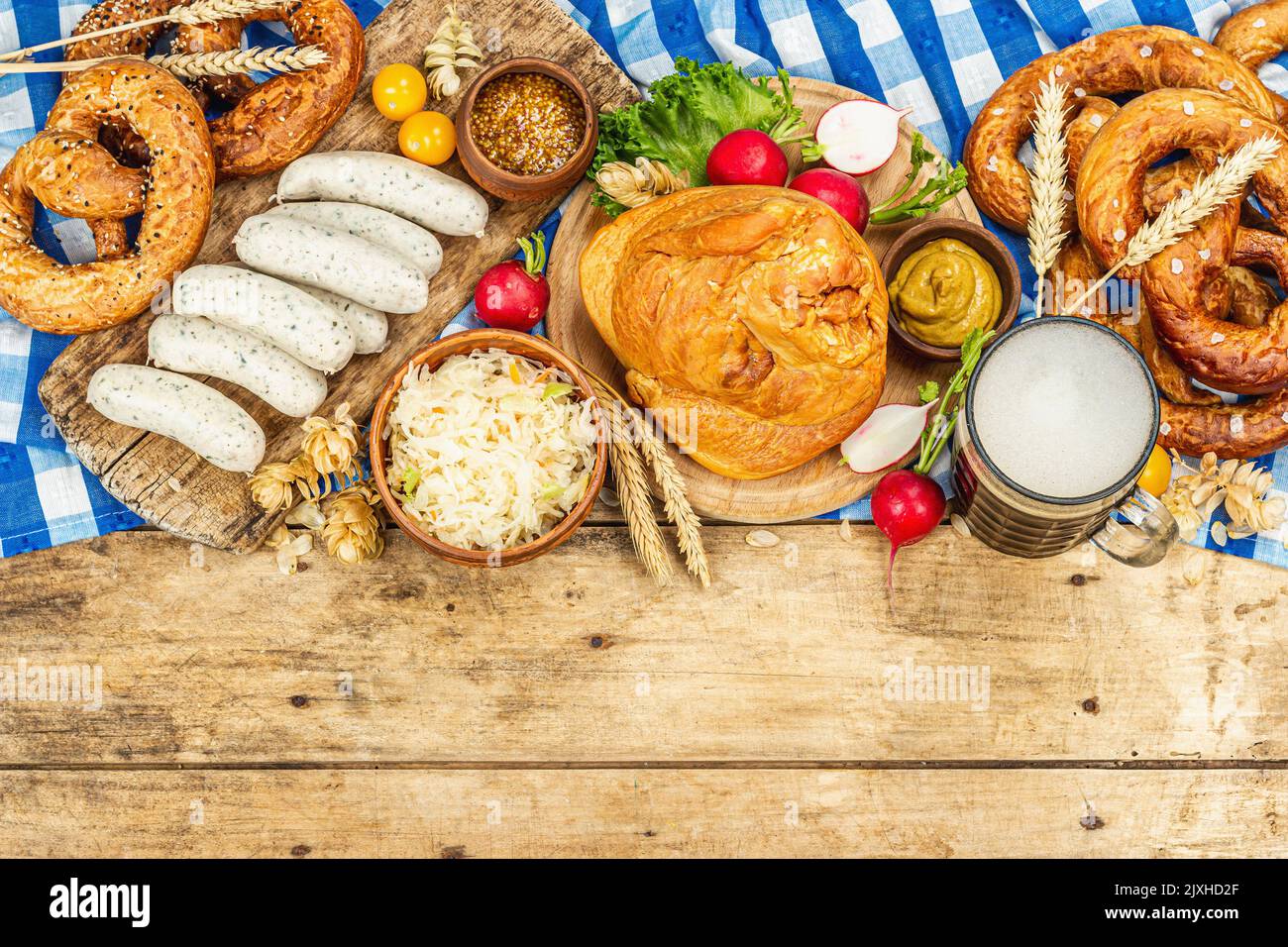 Traditional Oktoberfest set. Pretzels, beer, weisswurst, smoked pork ...