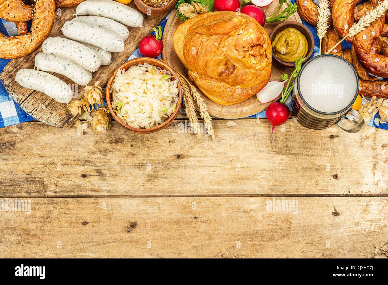 Traditional Oktoberfest set. Pretzels, beer, weisswurst, smoked pork ...