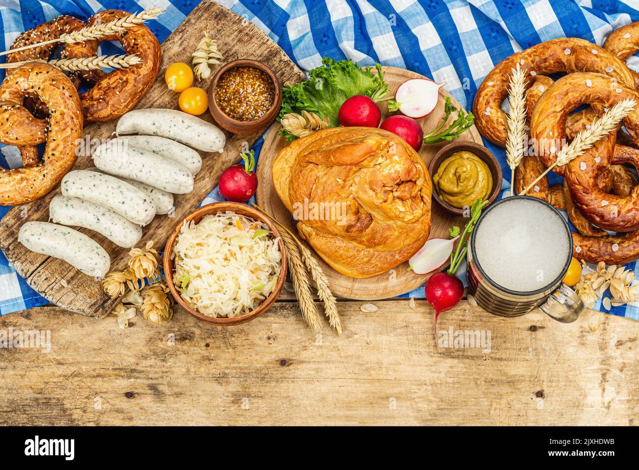 Traditional Oktoberfest set. Pretzels, beer, weisswurst, smoked pork ...
