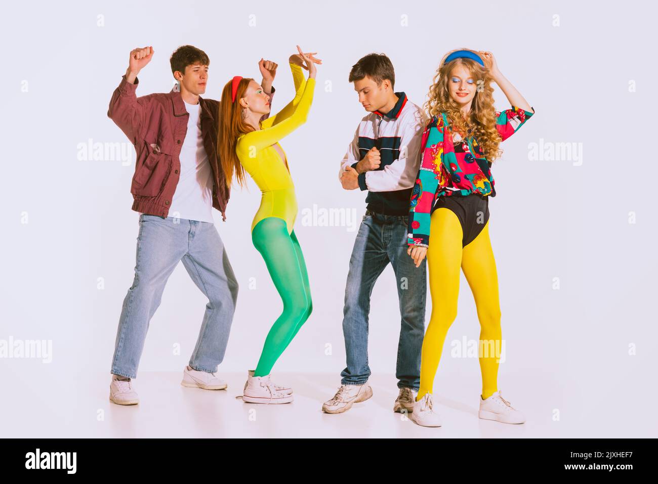 Group of stylish people, boys and girls in bright retro outfits dancing ...