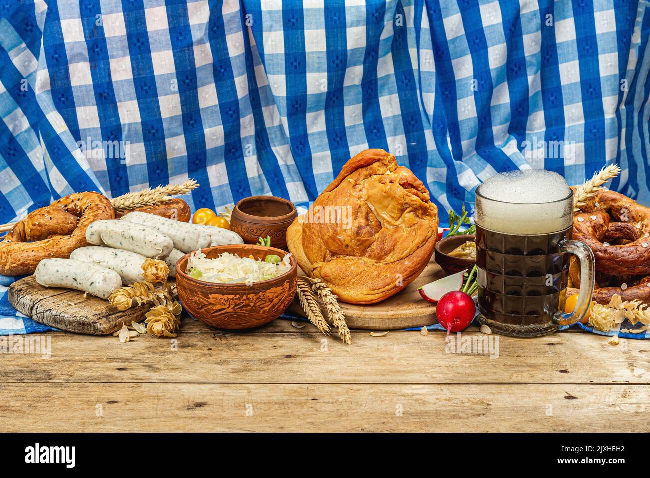 Traditional Oktoberfest set. Pretzels, beer, weisswurst, smoked pork ...