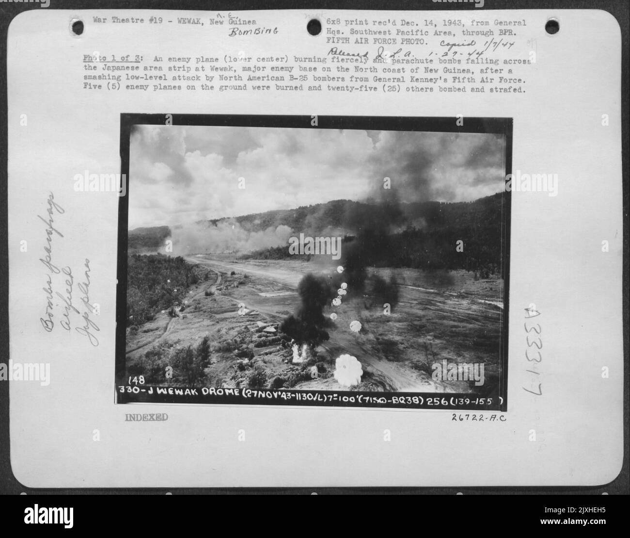 An enemy plane (lower center) burning fiercely and parachute bombs ...