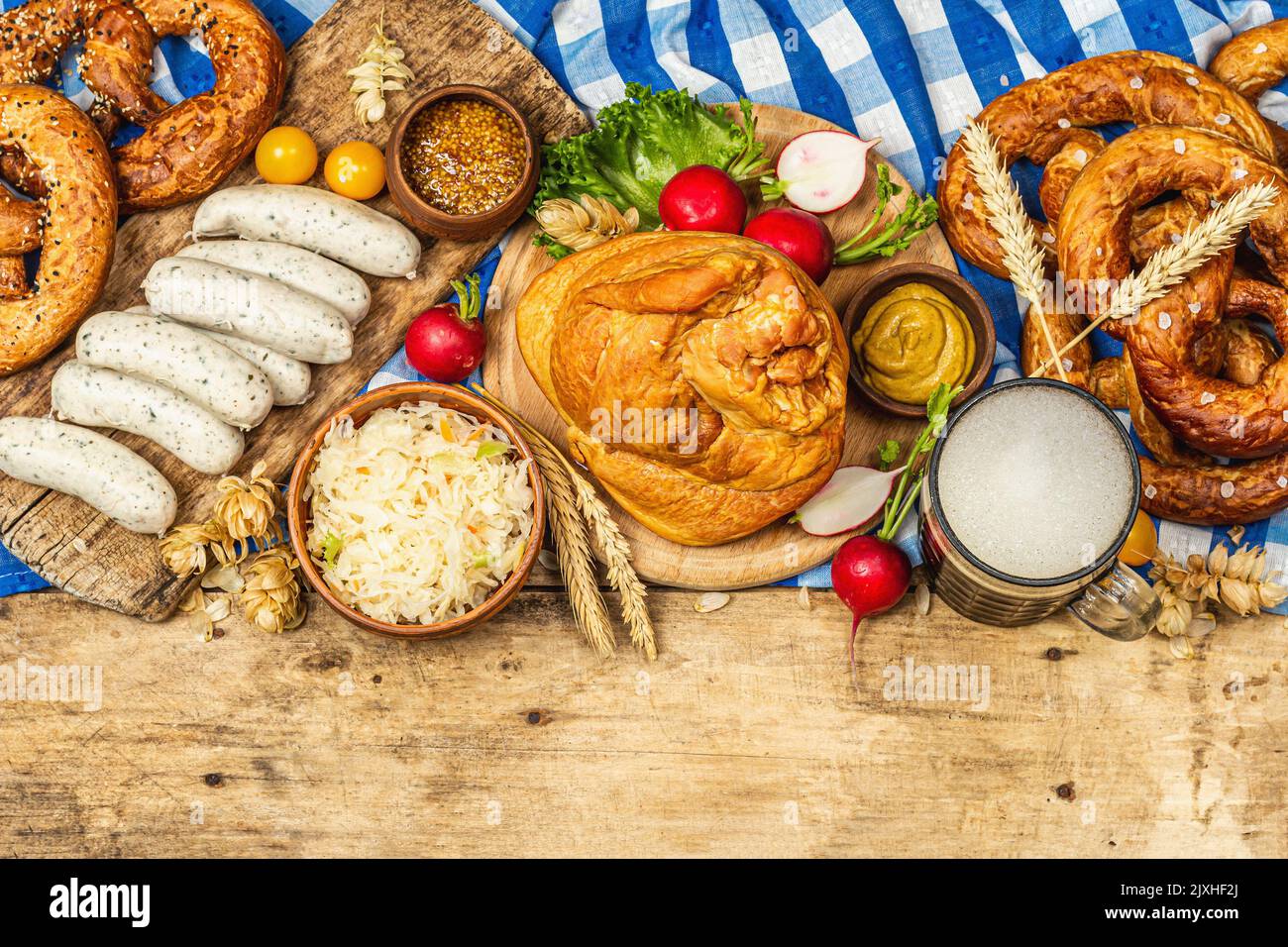 Traditional Oktoberfest set. Pretzels, beer, weisswurst, smoked pork ...