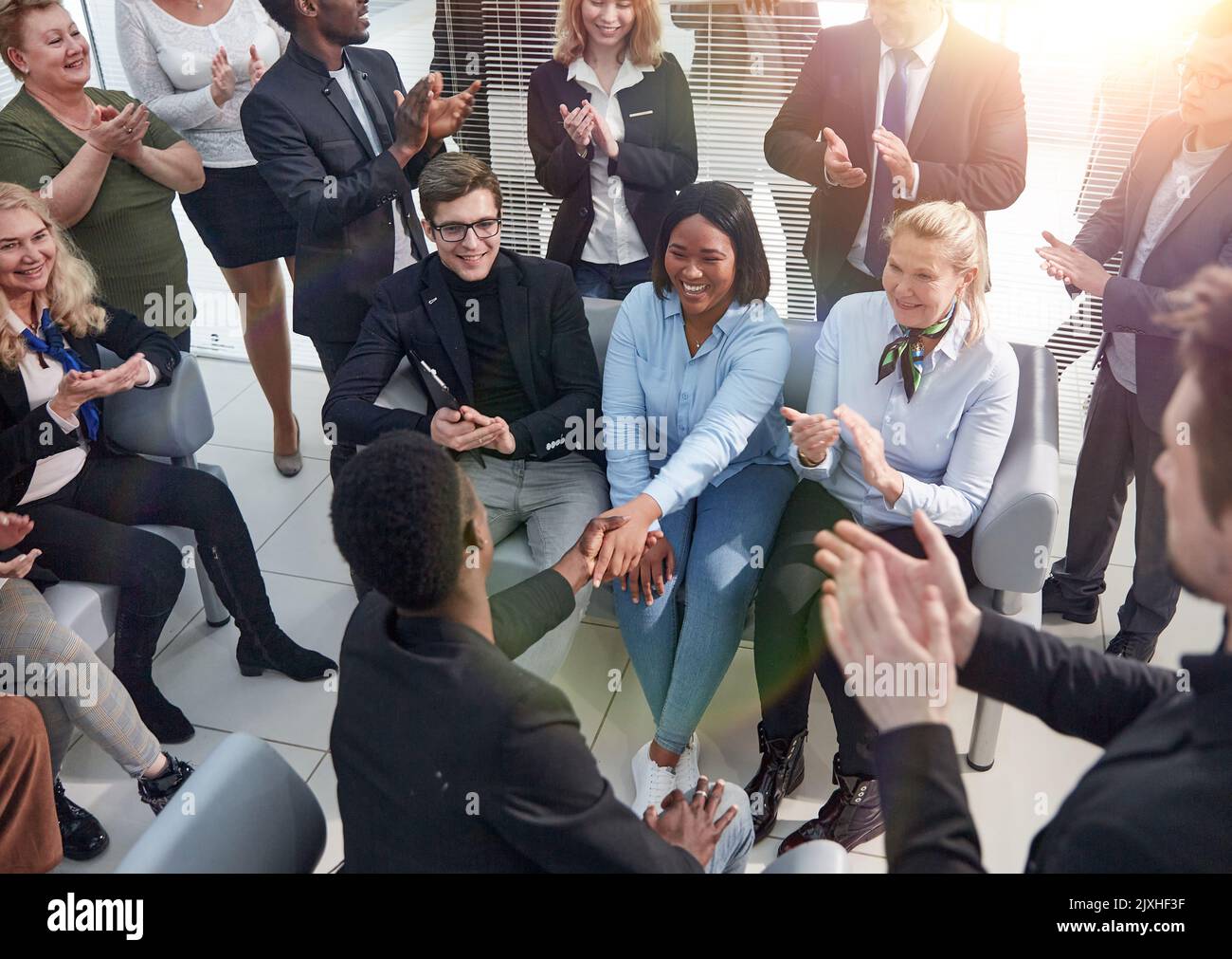 employees greeting their new colleague with applause Stock Photo - Alamy