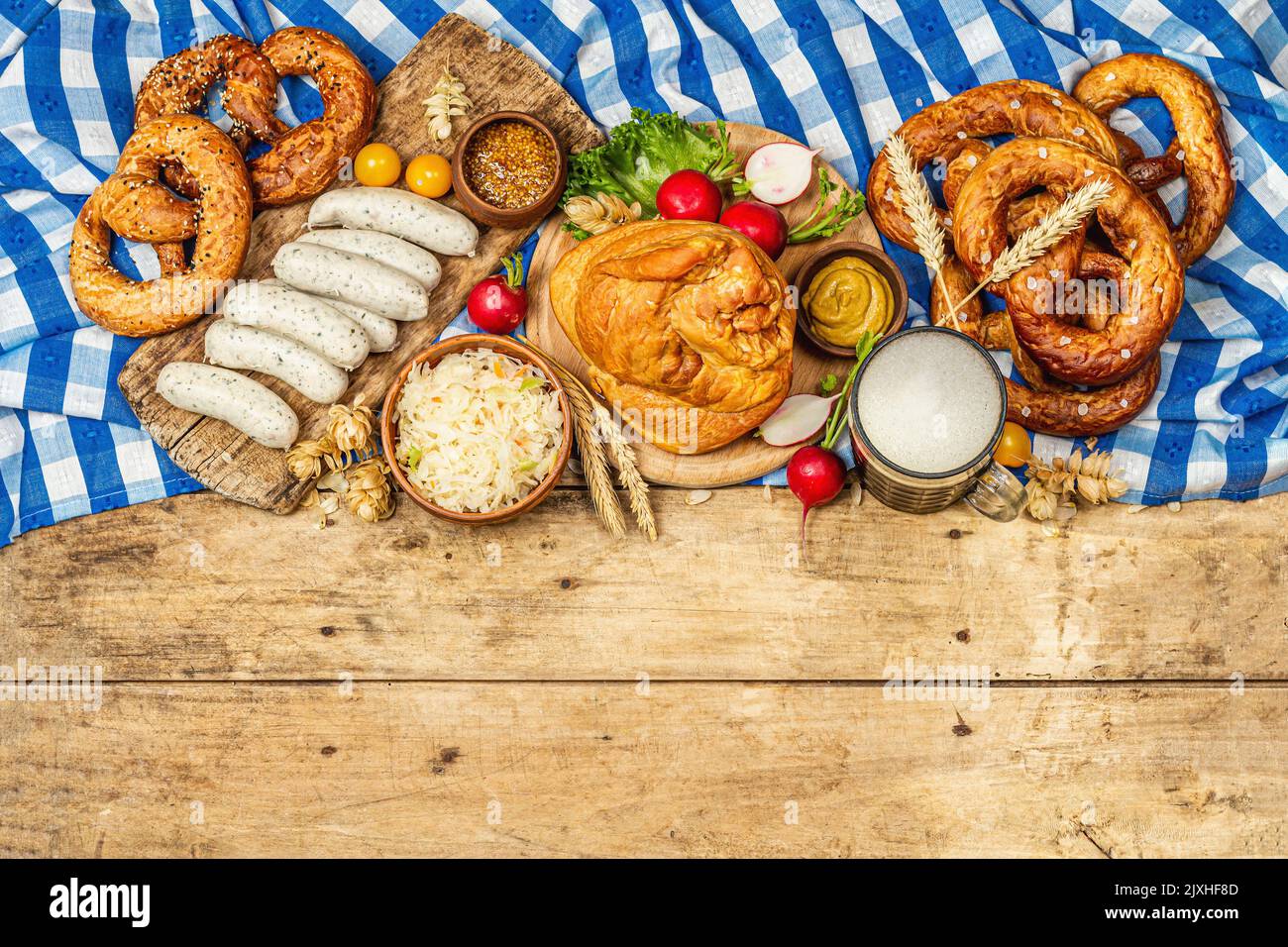 Traditional Oktoberfest set. Pretzels, beer, weisswurst, smoked pork ...