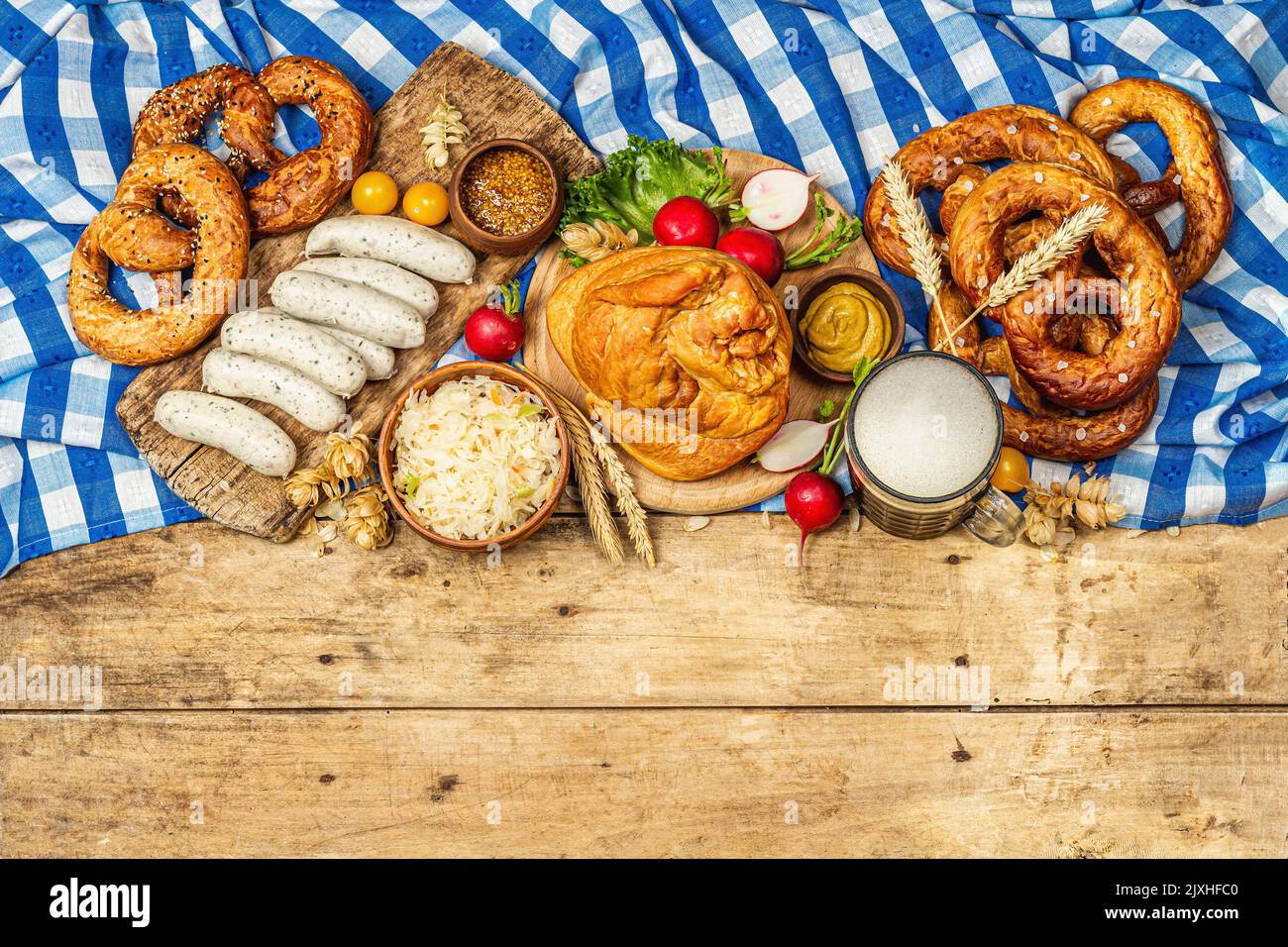 Traditional Oktoberfest set. Pretzels, beer, weisswurst, smoked pork ...