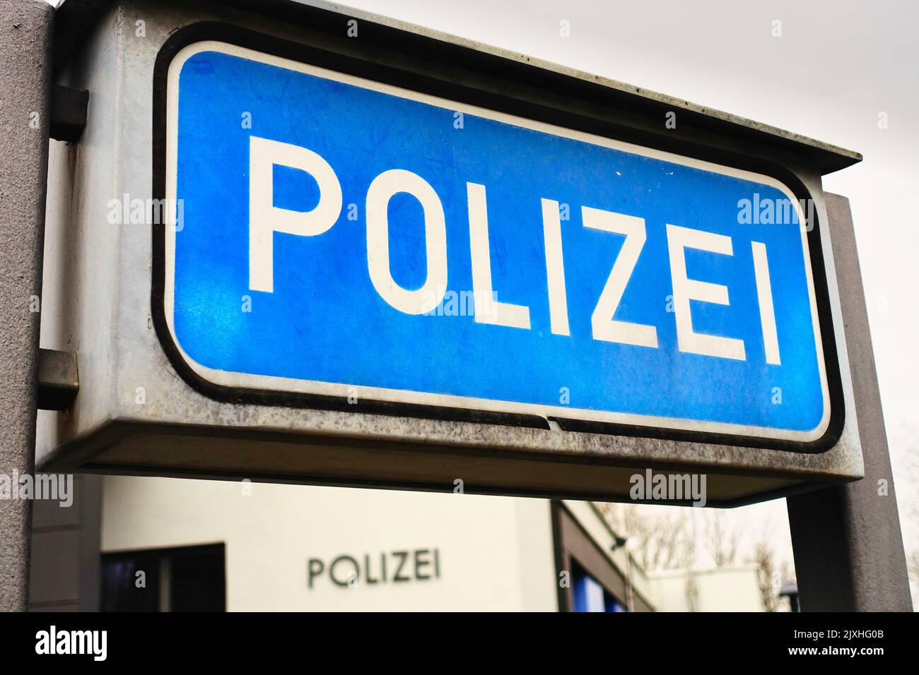 A blue sign with the inscription "Poizei" for "police" at a German ...