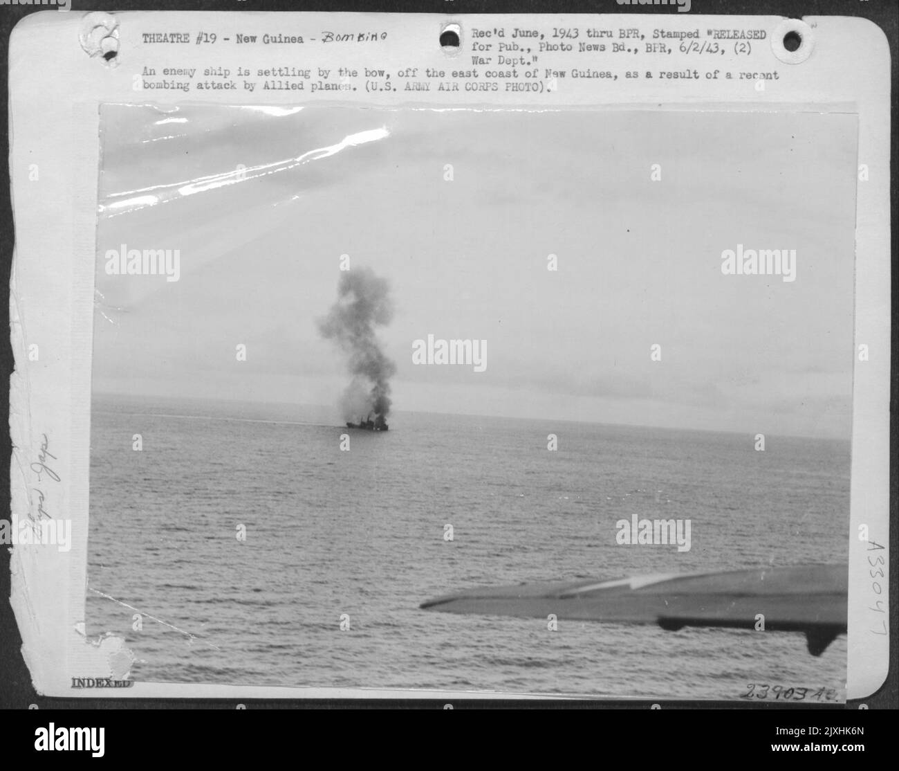 An enemy ship is settling by the bow, off the east coast of New Guinea ...