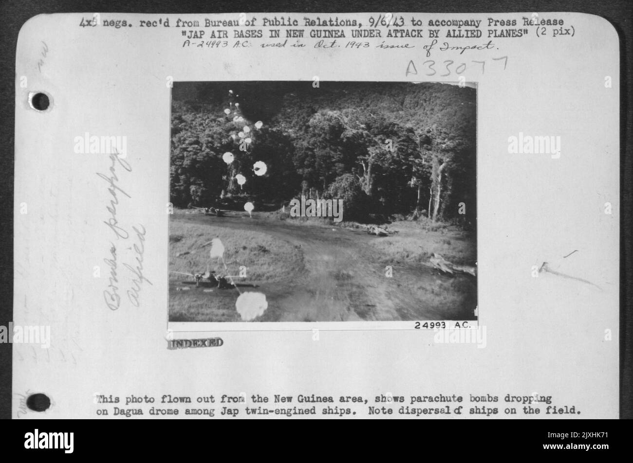 This photo flown out from the New Guinea area, shows parachute bombs ...