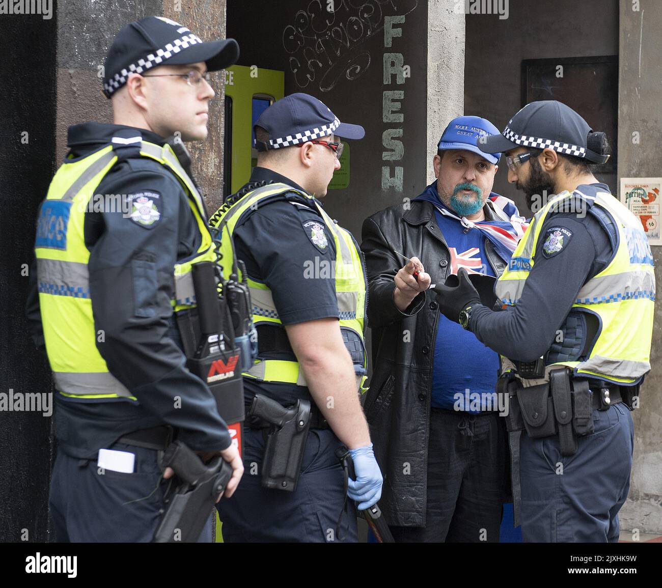 Police speak to a member of the True Blue Crew during a True Blue Crew ...