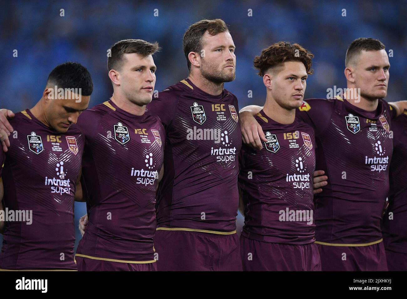 Queensland Maroons players sing the national anthem during Game 2 of ...